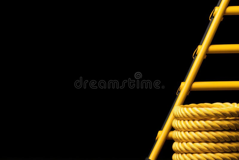 Yellow Ladder with Coiled Rope Against a Black Background Stock Image ...