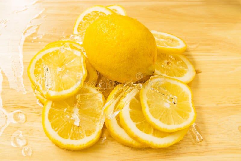 Yellow Lemon Slice into Pieces with Ice Stock Image - Image of cold ...