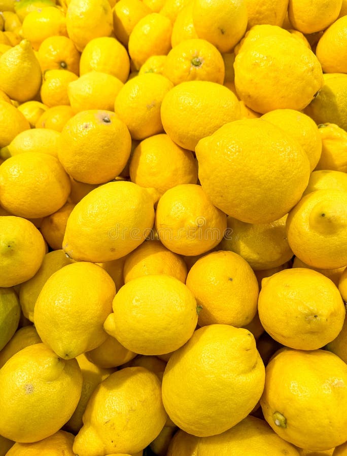 Yellow Lemons on a Counter in a Market As an Abstract Background ...