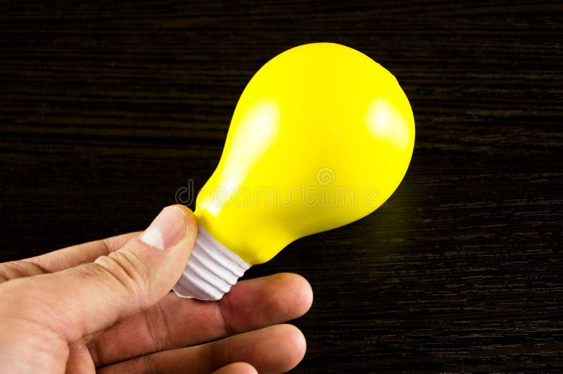 Yellow Light Bulb As a Symbol of Idea on a Dark Background Stock Image ...