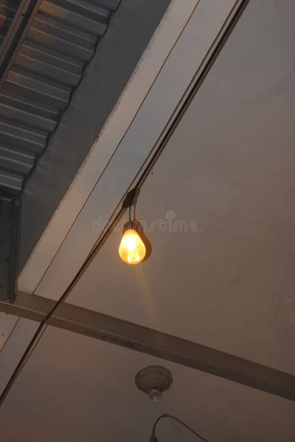 Yellow Light Bulb on the Wall of the House Stock Photo - Image of ...