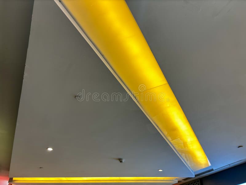 A Yellow Lighted Ceiling with a White Stripe Stock Image - Image of ...