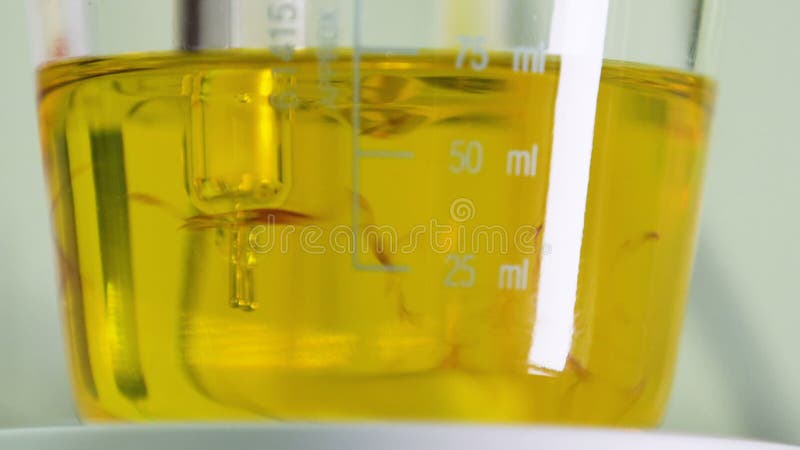 Yellow Liquid with Dark Impurities Mixed by Tool Macro Stock Video ...