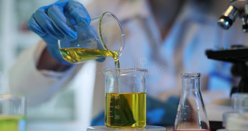 Yellow Liquid Flows from a Flask in a Laboratory Closeup Stock Video ...