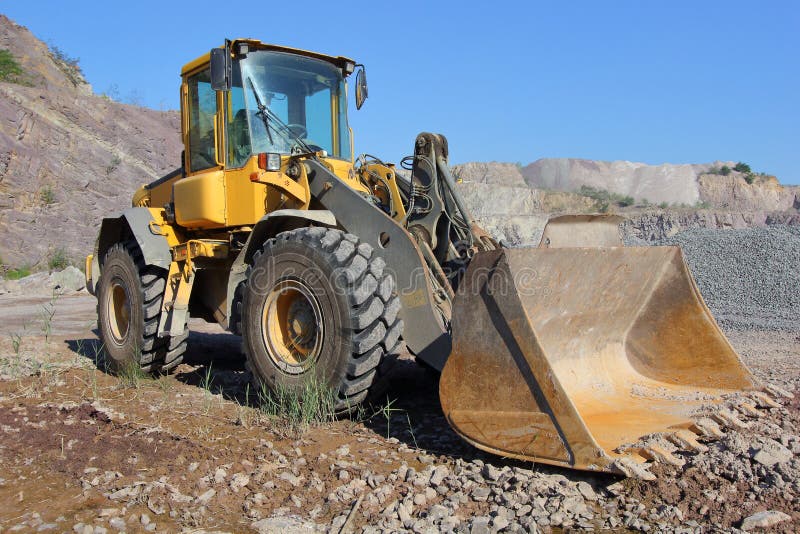 A Yellow Loader in the Middle of a Stone Quarry Stock Photo - Image of ...