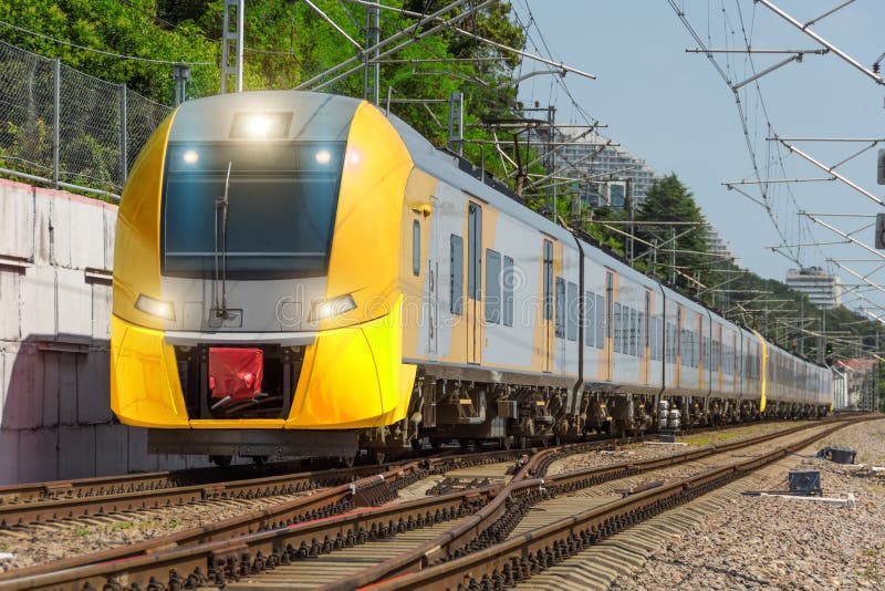 Yellow Long Suburban Passenger Electric Train Rides on the Railway ...
