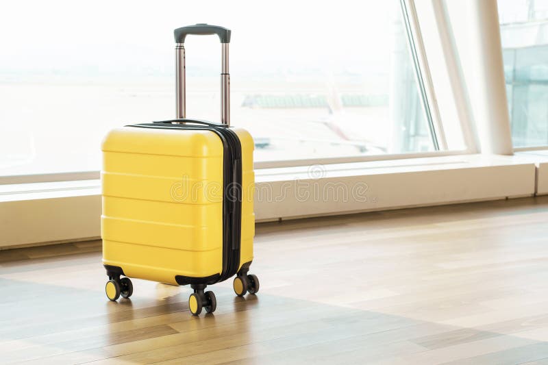 Yellow Luggage Bag on Wheels at the Airport, Side View. Stock Photo ...