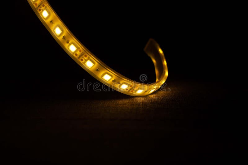Yellow Luminous LED Strip on a Dark Background.decorative Diode Tape ...