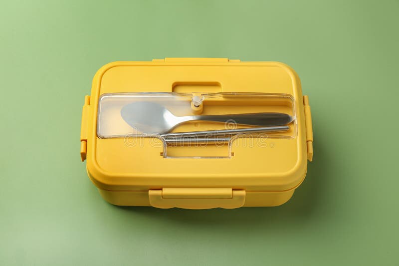 Yellow Lunch Box with Cutlery on Green Background Stock Photo - Image ...