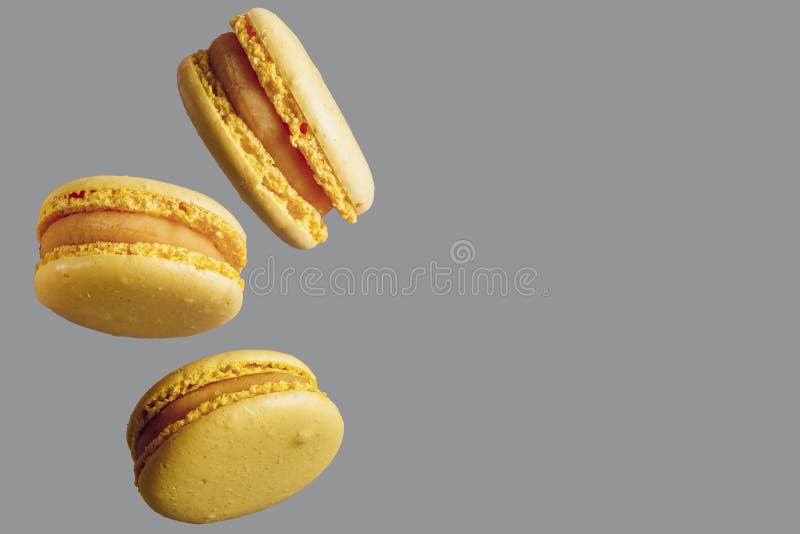 Yellow Macaroons in Motion Falling on Gray Background. Trend 2021 Color ...