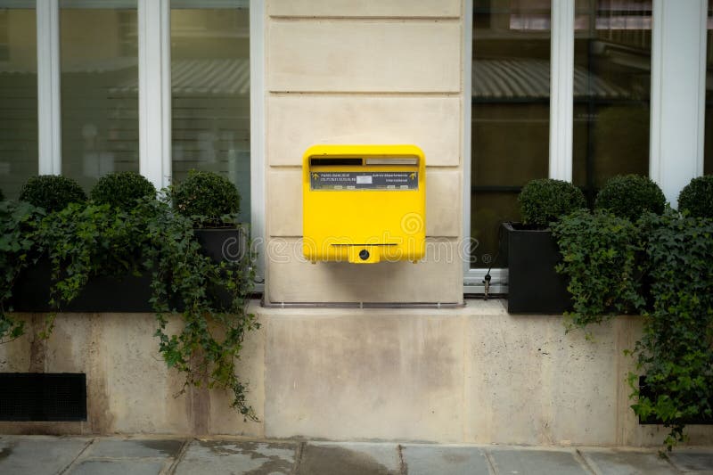 Yellow Mailbox on Beige Wall with Green Plants Stock Photo - Image of ...