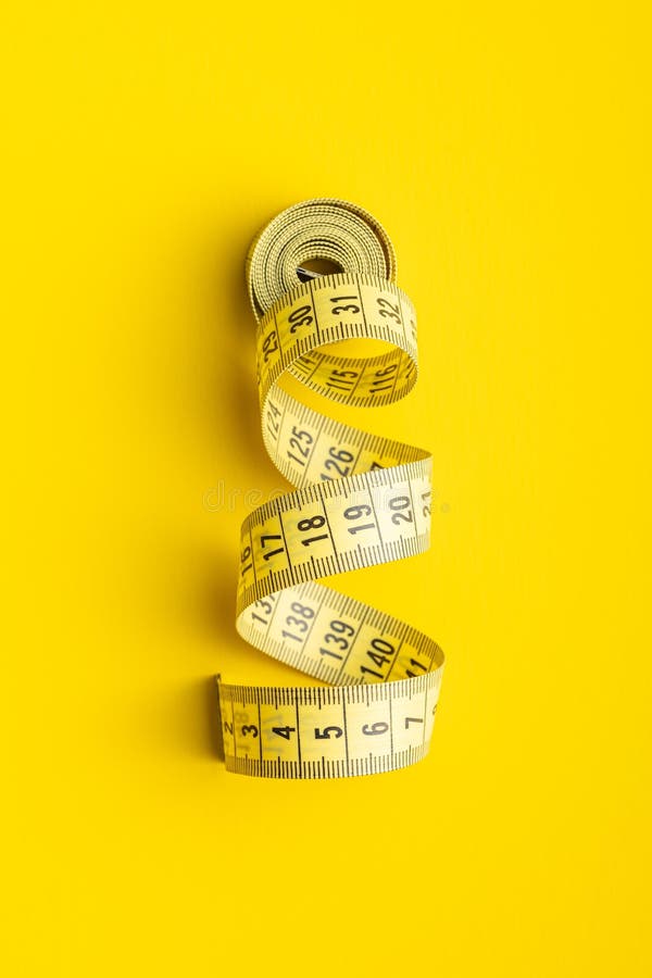 Yellow Measuring Tape on Yellow Background. Top View Stock Photo ...