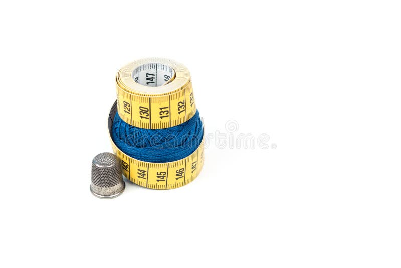 Yellow Measuring Tape on Top of Blue Sewing Thread with Silver Thimble ...