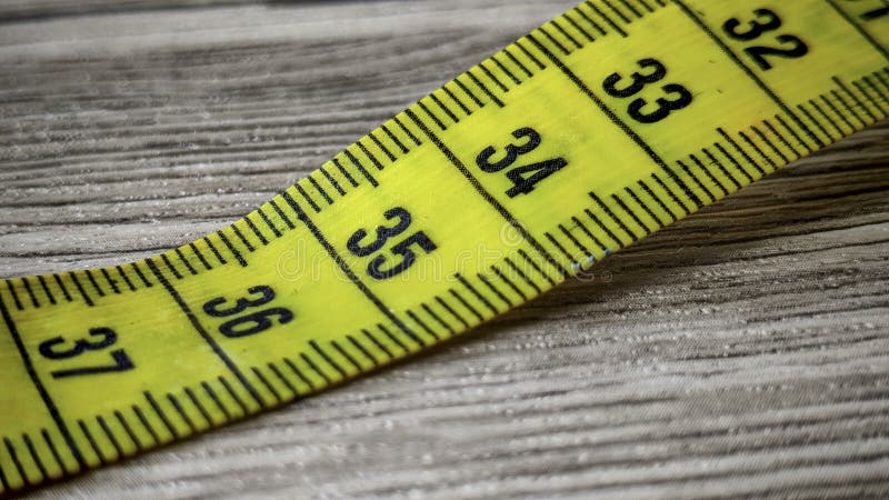 Yellow Measuring Tape on Wooden Surface Stock Photo - Image of ...