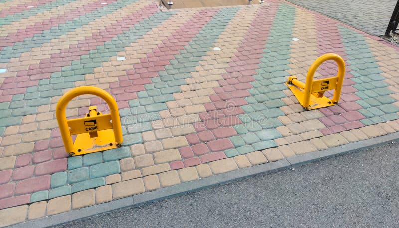 Yellow Mechanical Parking Barrier with a Lock on the Gray Aswhite ...