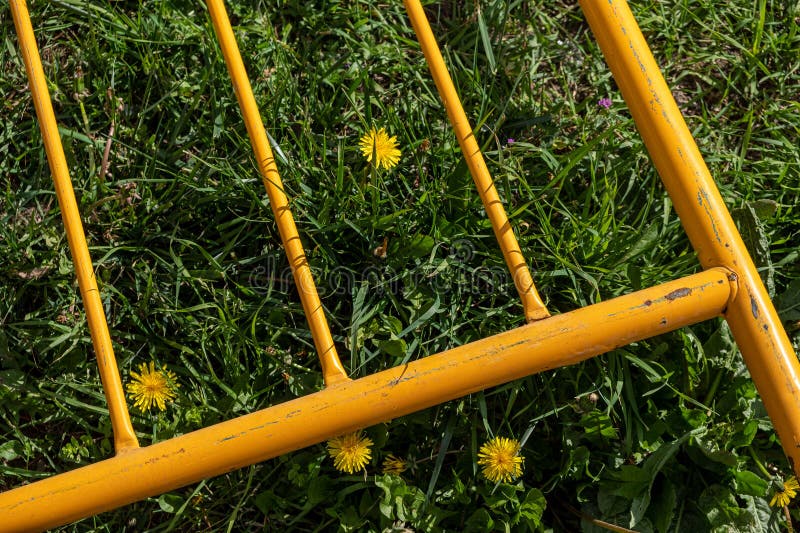 Yellow Metal Fence Lying on the Green Grass Stock Photo - Image of ...
