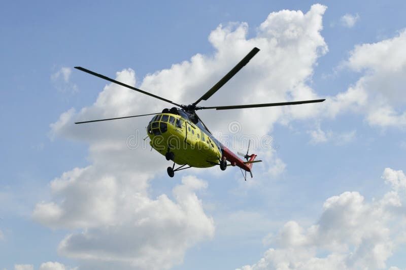 The Yellow MI-8 Helicopter Flies Against Clouds. Editorial Stock Image ...