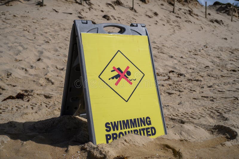 Yellow No Swimming Sign on a Beach Stock Image - Image of swim ...