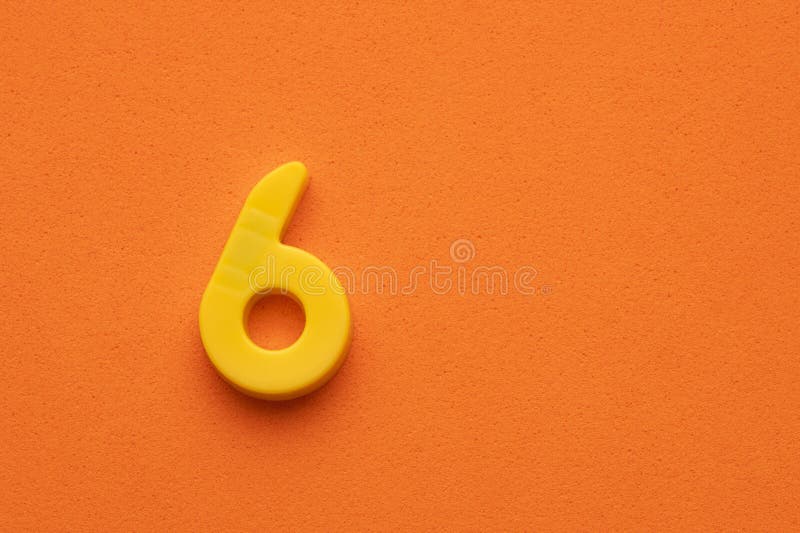Yellow Number 6 - Plastic Piece on Orange Foamy Background Stock Image ...