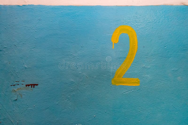 Yellow Number Two on the Blue Painted Wall Stock Photo - Image of dirty ...