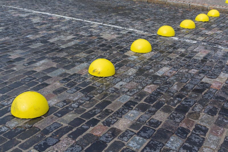 Yellow Obstacles on the Pavement Stock Photo - Image of barricade ...