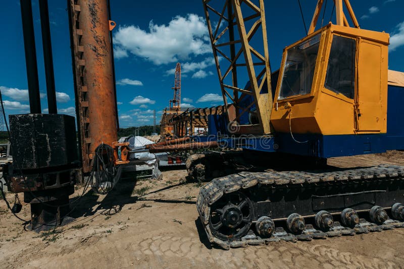 Yellow Pile Driver with Large Caterpillars on a Sunny Day Stock Photo ...