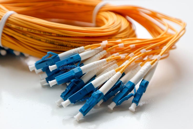 Yellow Optical Fiber Network Cable with Blue Connectors Isolated on ...