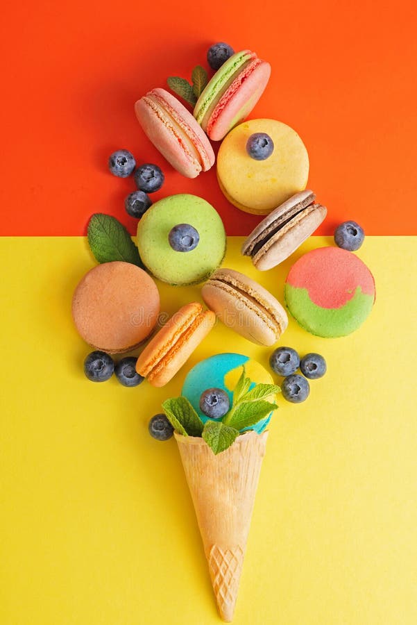 On a Yellow-orange Background, Macaroons, Mint Leaves, Blueberries and ...