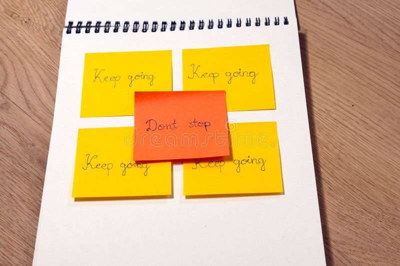 A Yellow and Orange Sticky Note with the Word "don T Stop" Written on ...