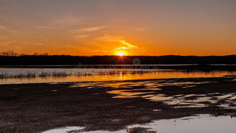 The Yellow-orange Sun Setting Behind the Trees on Dyer Creek in Dover ...