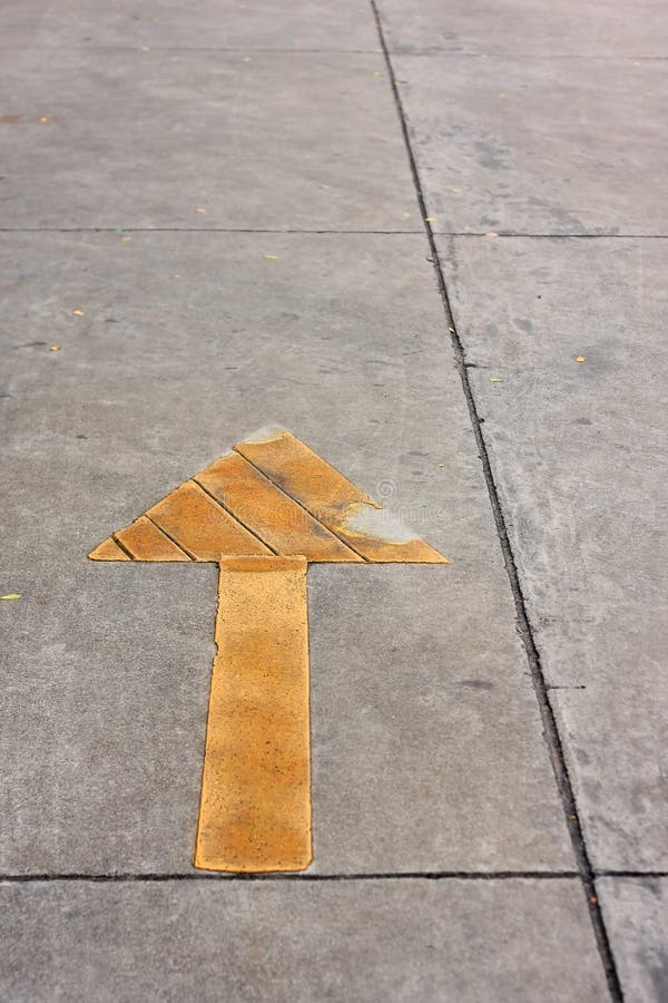 Yellow Painted Arrow Sign on Street Stock Photo - Image of background ...