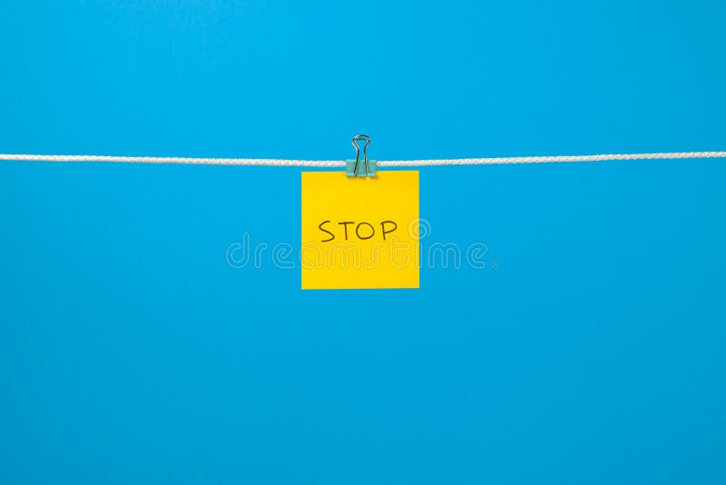 Yellow Paper Sheet on the String with Text â€œStopâ€ Stock Image ...