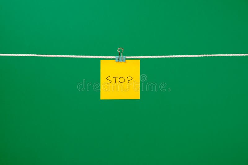 Yellow Paper Sheet on the String with Text â€œStopâ€ Stock Photo ...