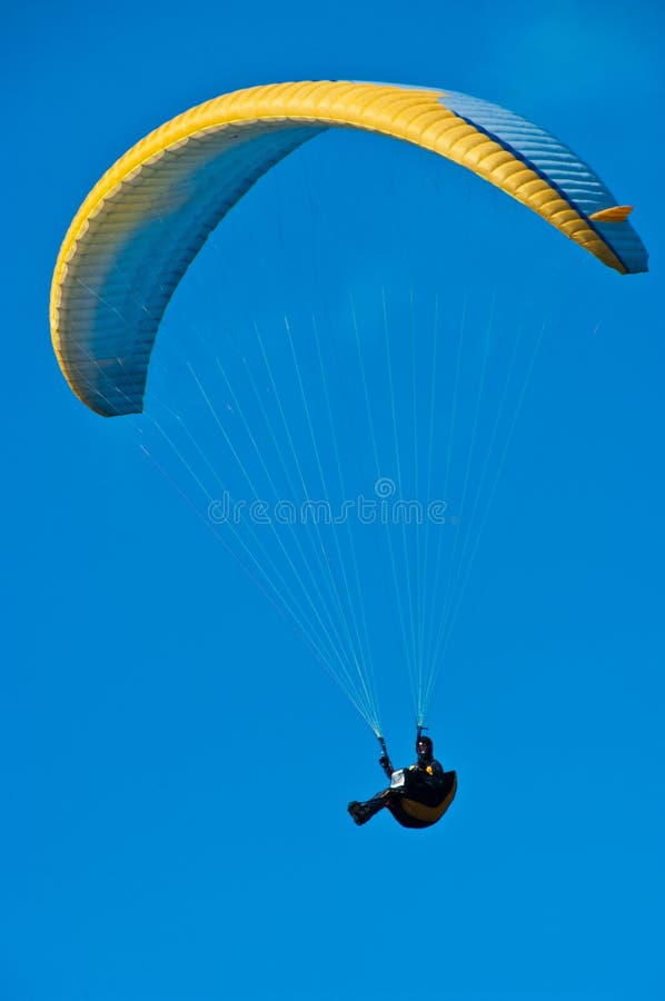 Yellow Parachute in Blue Sky Stock Image - Image of symmetry, male ...