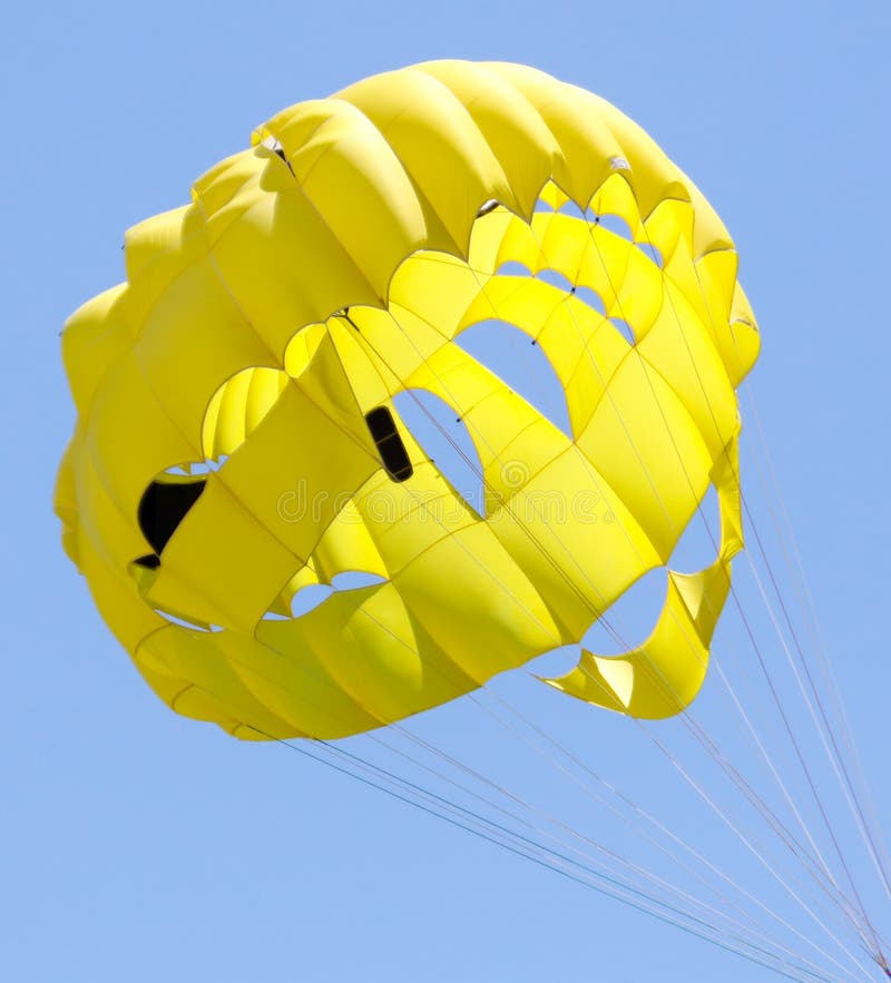 A Yellow Parachute Flies in the Sky Stock Photo - Image of paragliding ...