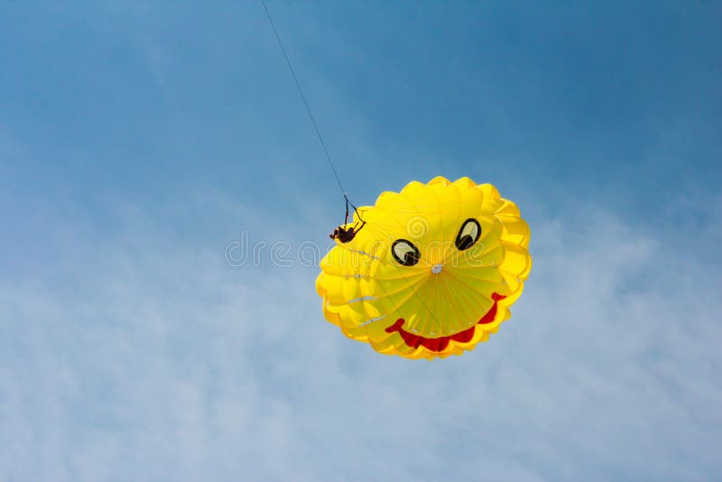 Yellow Parachute in the Sky. the Man is Flying by Parachute Stock Photo ...