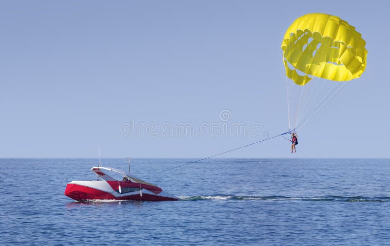 A Yellow Parasail Wing Pulled by a Powerboat. Guy Takes a Selfie Stock ...