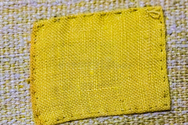 Yellow patch on a cloth stock photo. Image of texture - 205284076
