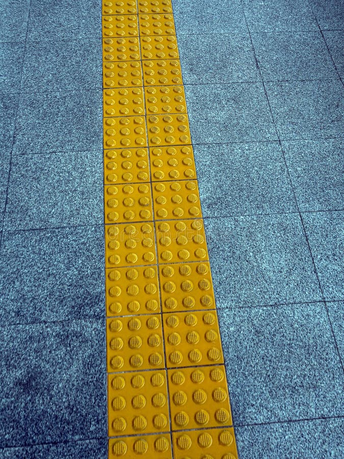 Yellow Pavement Has a Textured Surface To Serve As a Walking Guide for ...