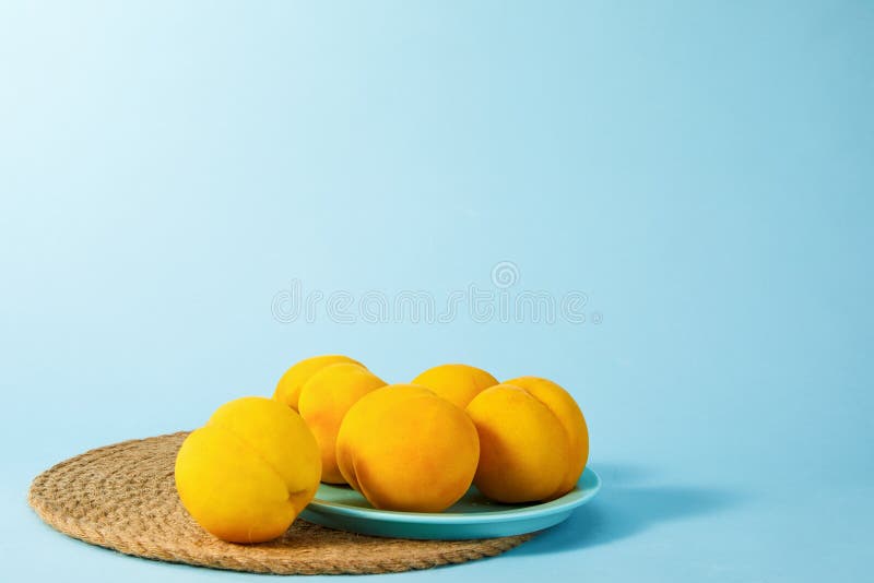 Yellow Peaches on a Light Blue Background Stock Photo - Image of peach ...