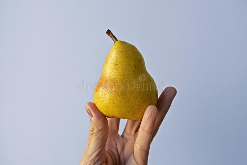 Yellow Pear on Hand in a Bright Background Stock Photo - Image of ...
