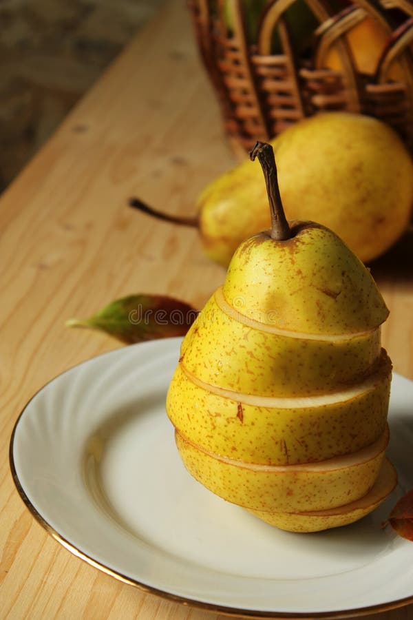 Yellow Pear, on a White Dish, by a Slozhenna Pyramid. Stock Image ...
