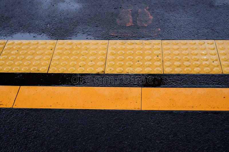 Yellow Pedestrian Path for the Disabled on Tiled Path Stock Photo ...