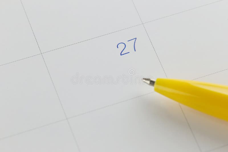 Yellow Pen Points To the Number 27 on Calendar Background. Stock Photo ...