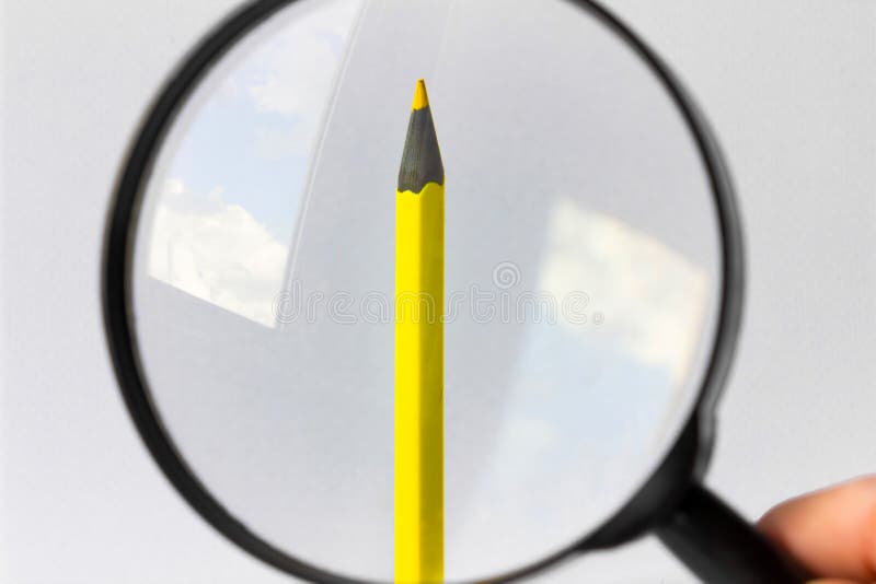 Yellow Pencil Under a Magnifying Glass Stock Image - Image of equipment ...