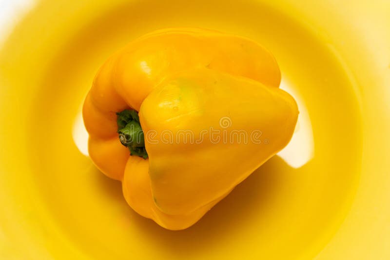 A Yellow Pepper Inside a Yellow Plate. Stock Photo - Image of hand ...