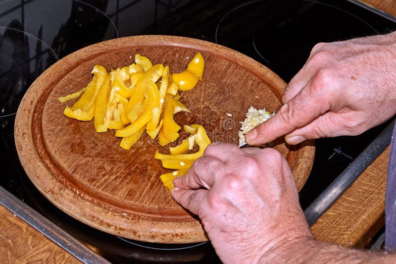 Yellow Peppers Capsicum Cut with a Knife on a Board. Stock Photo ...