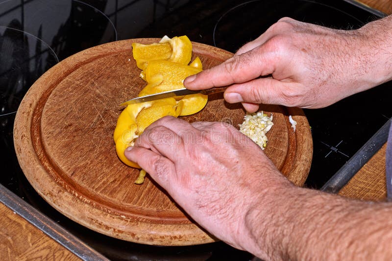 Yellow Peppers Capsicum Cut with a Knife on a Board. Stock Image ...