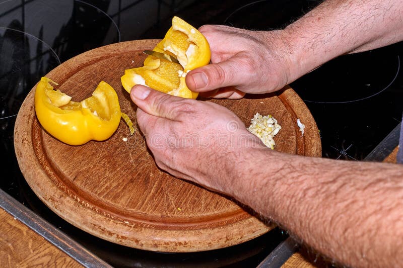Yellow Peppers Capsicum Cut with a Knife on a Board. Stock Photo ...