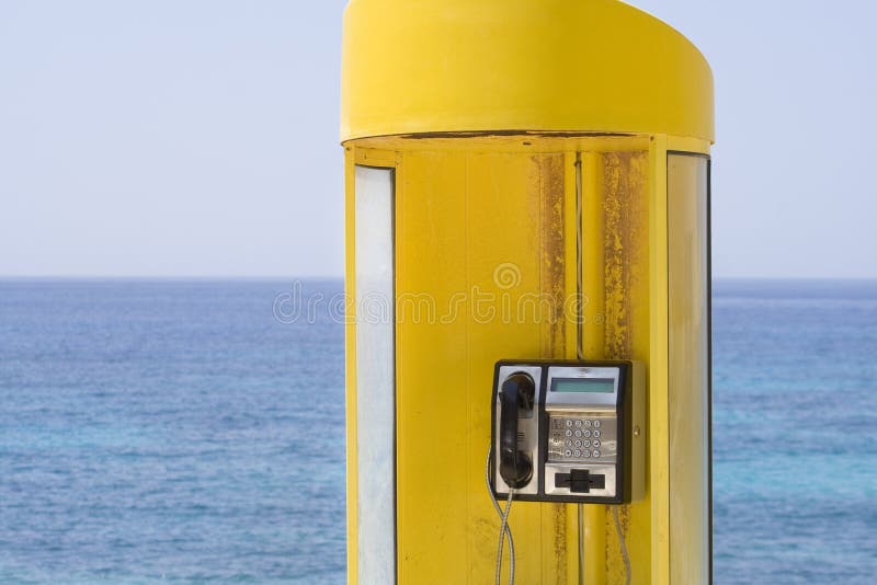 Yellow phone, blue sea stock photo. Image of kefalonia - 7651806